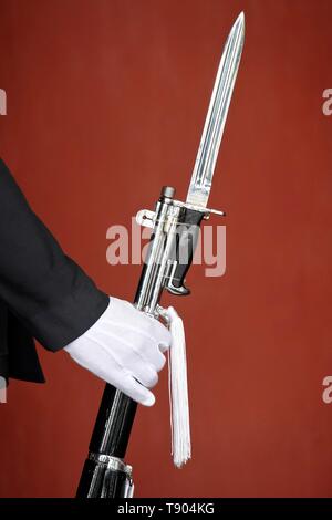 Closeup image of an armed soldier holding his gun in the battle field ...