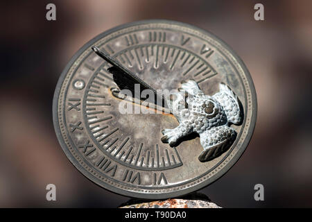 Frog and bird weathered brass sundial Stock Photo - Alamy