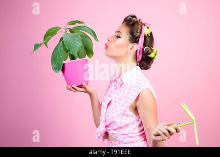 spring. greenhouse worker or gardener. pinup girl with fashion hair ...