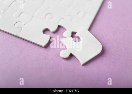 Incomplete jigsaw puzzle on color background Stock Photo - Alamy