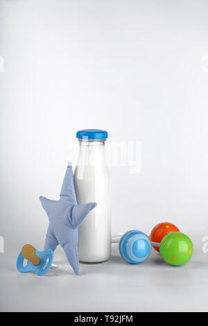 Baby milk with toys on white background. Top view Stock Photo - Alamy
