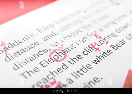 Sheet of paper with corrected mistakes in text on color background ...