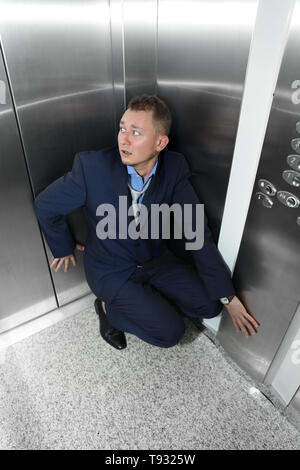 Business, person and fear of elevator with worry for trapped ...