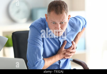 Heart attack and panic attack in the workplace. Young Indian man ...