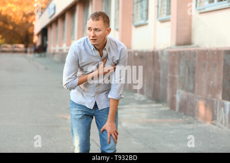 Man having panic attack outdoors Stock Photo - Alamy