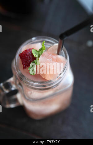 ice cubes with frozen fruits and mint stand pyramid on white background ...