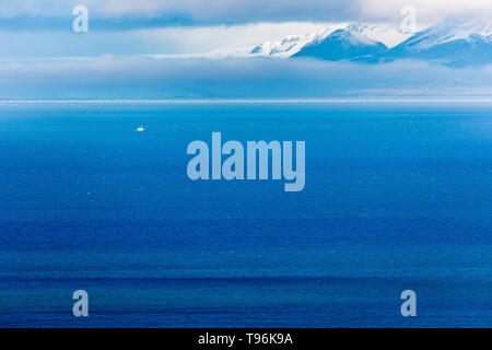 View across Isfjord in Svalbard, Blue water with boat and glaciers in ...