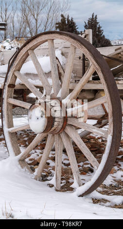 Weathered wagon against a scenic landscape blanketed with snow in ...