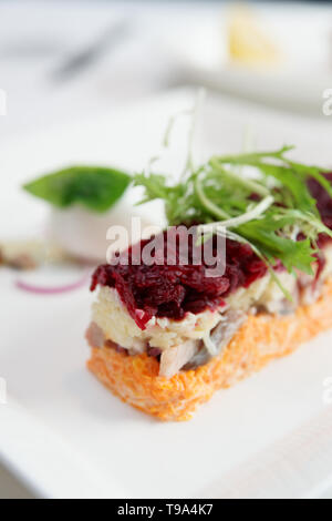 Shuba herring salad, a traditional dish, layering diced beets, eggs ...