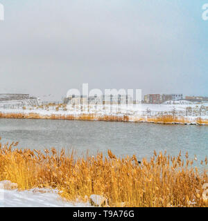 Square A gleaming lake with grasses lining the shore in Daybreak Utah ...