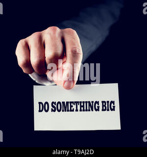 Hand of Businessman holding motivational message Stock Photo - Alamy