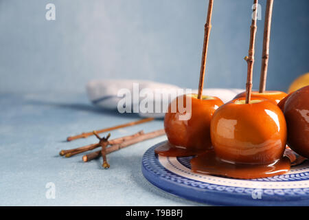 Delicious caramel apples with tree branches on wooden board Stock Photo ...