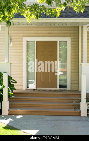 Door steps and concrete pathway leading to residential house main ...
