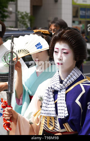 Japanese female kanabohiki (metal rod bearer) with shimada momoware ...