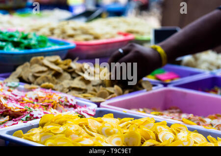 Colorful variety of fryums ready to fry snacks in an indian market ...