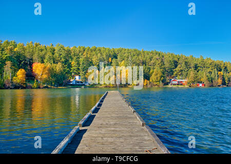 Dock and cottages and Autumn on Crow Lake (also known as Kakagi Lake ...