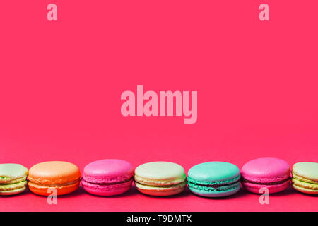 Macaron pink, orange and beige, blue on marble style. French dessert on ...