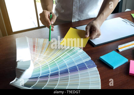 Graphic designer choose colors from the color bands samples for design ...