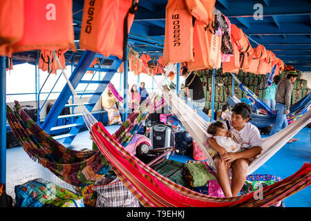 Hammocks for passengers set on the deck of the lancha or ferry that ...