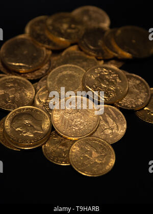 Real Gold coins over dark background Stock Photo - Alamy