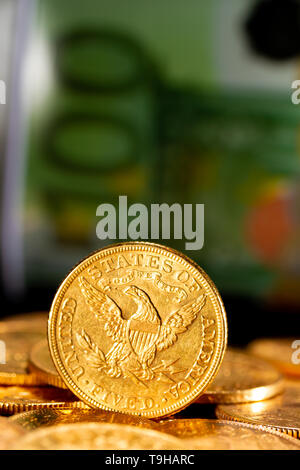 Real Gold coins over dark background Stock Photo - Alamy