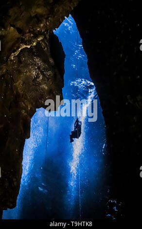 A potholer is winched into Gaping Gill, the largest cavern in Britain ...