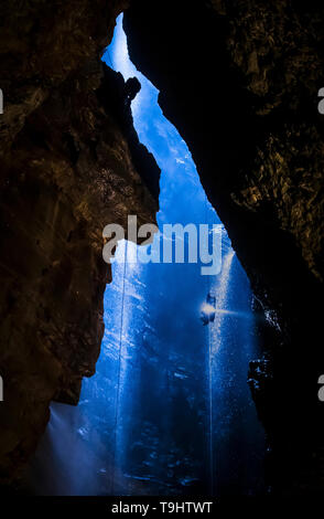 A potholer is winched into Gaping Gill, the largest cavern in Britain ...