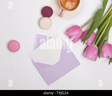 Top view with pink tulips and notebook on pink background. Business ...