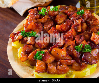 Delicious spanish dish Morro de cerdo, braised pig snout served in clay ...