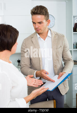 Elderly woman tries to persuade young man don't worry Stock Photo - Alamy