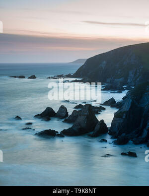 Beautiful sunset landscape image of Westcombe Beach in Devon England ...