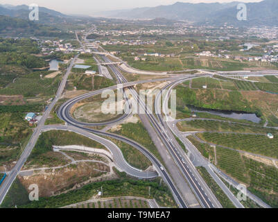 Overhead view of curved off ramp leading from expressway to country ...