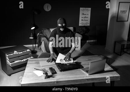 Male thief indoors, view through security camera Stock Photo - Alamy