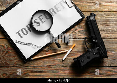 Composition with different items for detective on wooden table Stock ...