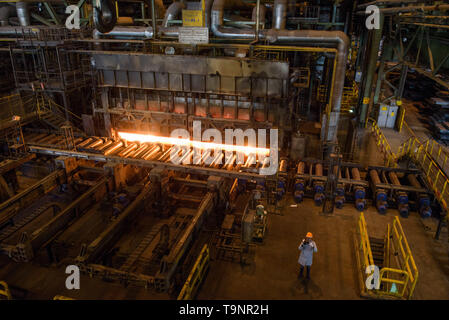 Esfahan, Iran. 19th May, 2016. Glowing steel rolls through a mill at ...