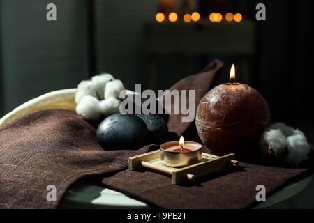 Beautiful spa composition with burning candles and towels on wooden ...
