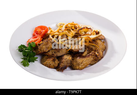 Fried rabbit liver served on white plate with grilled onion and cherry ...