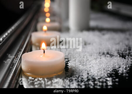 Many burning candles and sea salt on tray Stock Photo - Alamy
