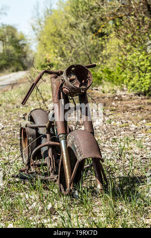 Rusted frame of a motorcycle an abandoned village in Belarus, Chernobyl ...
