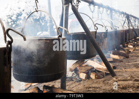 View of iron cauldrons for cooking outdoors in medieval style in open ...