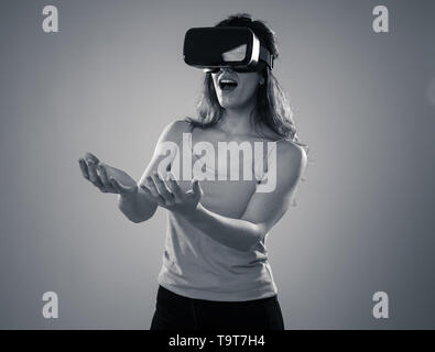 Young woman in goggles exploring virtual reality Stock Photo - Alamy
