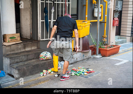 Man crushing tin can Stock Photo - Alamy