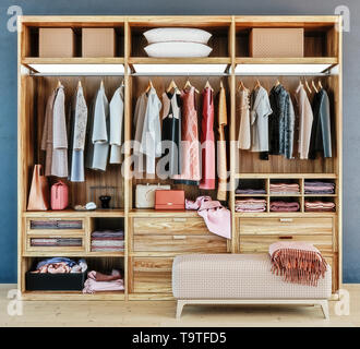 A 3d rendering of a closet with clothes in it against a white ...
