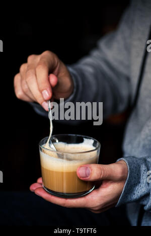 man hand use spoon mix coffee and sugar in the morning. cake and coffee ...