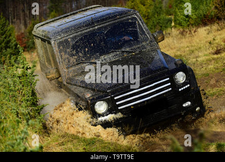 off road car overcomes the track Stock Photo - Alamy