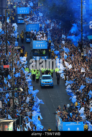 The players and staff on the buses pass the crowds of fans during the ...