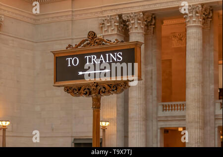 A decorative sign directing passengers to train platforms inside ...