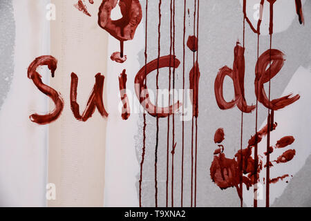 Word SUICIDE written in blood on floor Stock Photo - Alamy