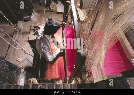 Weaver weaving Varanasi sari silk thread with handloom in Varanasi ...