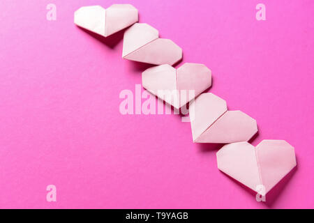 Origami hearts on color background Stock Photo - Alamy